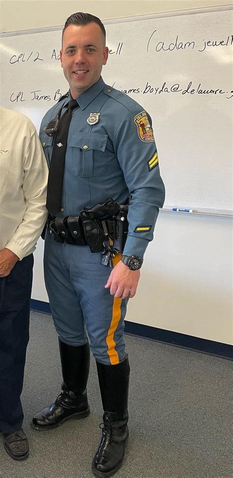 Two Police Officers Standing Next To Each Other In Front Of A
