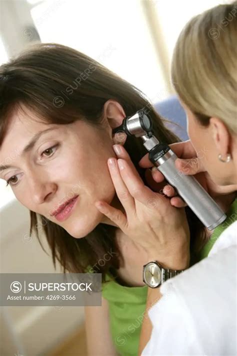 Female Doctor Examining The Ears Of A Female Patient With An Otoscope