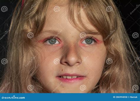 Portrait Of A Smiling Beautiful Blonde Girl With Curly Hair And Pink