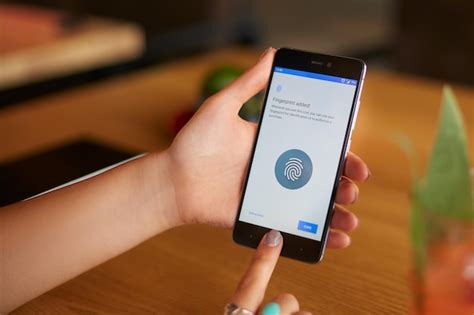 Premium Photo Female Scanning Fingerprint On Her Smartphone With Program Script On Laptop