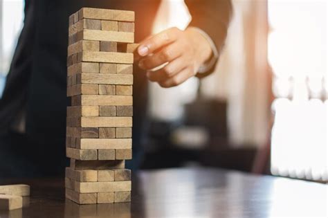 Premium Photo Businessman Picking Wooden Block Fail Danger Tower
