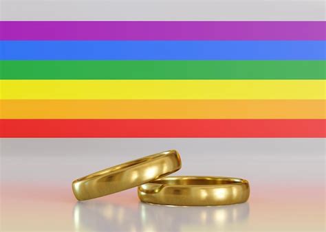 Premium Photo Two Gold Wedding Rings And Rainbow Lgbt Flag Equal