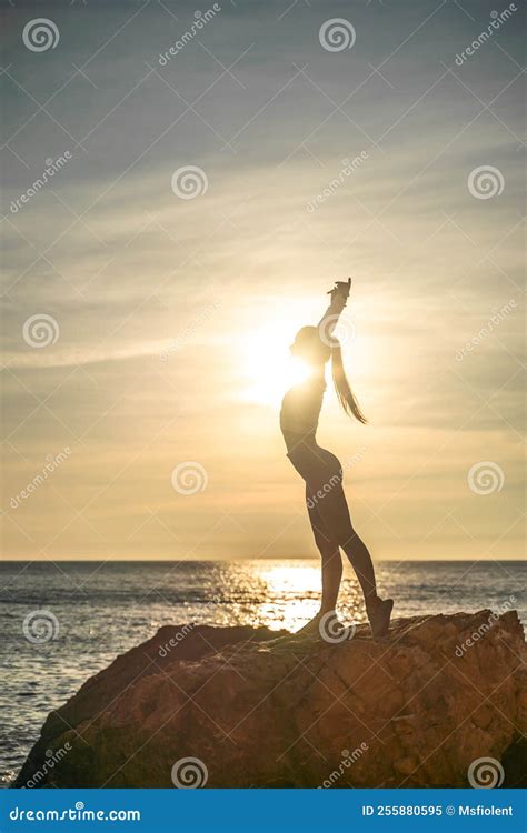 Girl Gymnast Is Training On The Beach By The Sea Sunset Does Twine