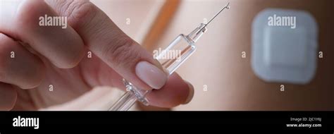 Woman Holding Syringe Filled With Medicine Liquid And Patch On Arm