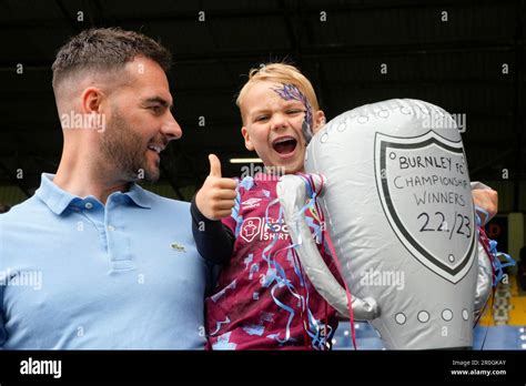 A Young Clarets Fan Holds An Inflatable Championship Trophy Before The