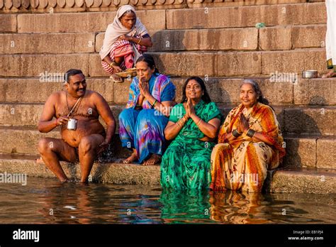 Hindu Pilgrims Praying And Bathing In The Holy River Ganges Varanasi