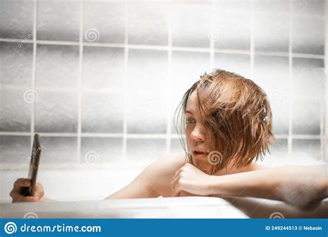 Sensual Middle Aged Woman Takes A Bath And Communicates On A Mobile