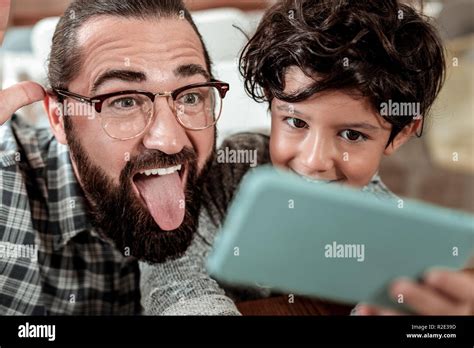 Funny Bearded Father Posing For Selfie With His Cute Handsome Son Stock