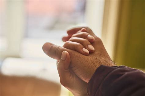 Close Up Photo Of Person Holding A White Cup Of Coffee In Both Hands