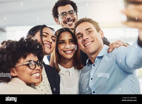 Fun United Colleagues Taking A Selfie With A Phone Looking Excited