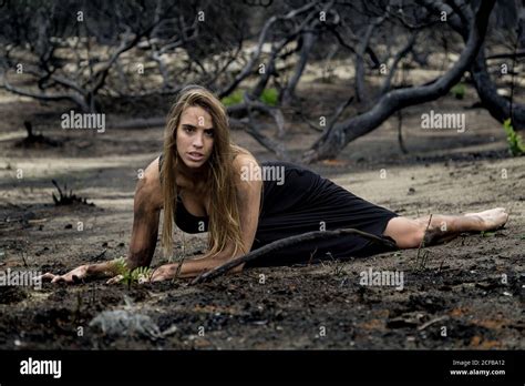 Side View Of Young Ballerina In Black Wear Posing On Land Between Dry