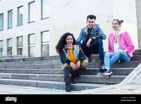 Cute Group Of Teenages At The Building Of University With Books