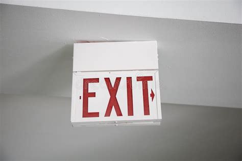 Red And White Exit Sign Hanging From The Ceiling Under The Lights Stock Photo Image Of