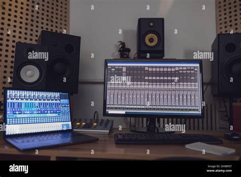 Overhead View Of Switched On Laptop And Monitor Screen On Table In A