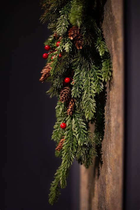 Wanddeko mit künstlicher Tanne Beeren und Zapfen 66 cm grün rot