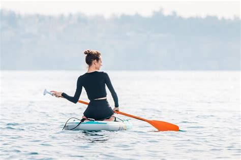Premium Photo Happy Girl In A Swimsuit With A Paddle Swims On A Sup