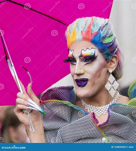 An Extravagant Drag Queen With A Pink Umbrella Attending The Gay Pride