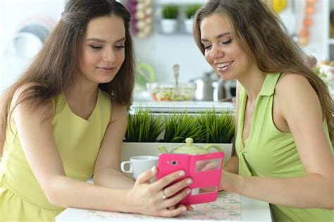 Premium Photo Two Girls Using Smartphone