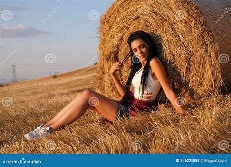 Woman On Hay Bale In Field At Sunset Stock Image Image Of Field