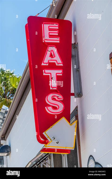 Eats Neon Sign With Arrow Pointing Down At Industrial Eats Restaurant