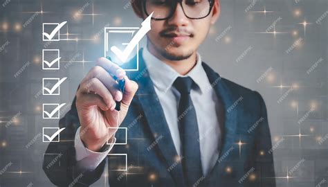 businessman using pen to tick correct sign mark in checkbox for quality