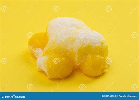 Freeze Dried Lemon Flavored Candy On A Bright Yellow Background Stock Image