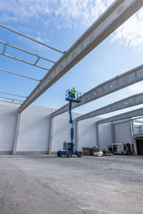 Warehouse Construction Worker On Mobile Elavating Work Platform Stock