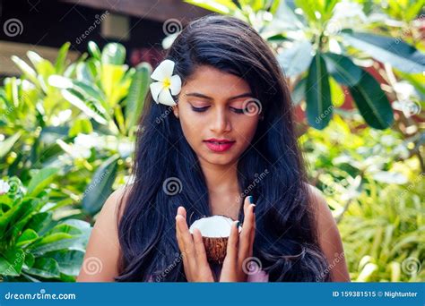 Indian Woman Applying Coconut Oil Dark Brunette Long Hair In A Hand On