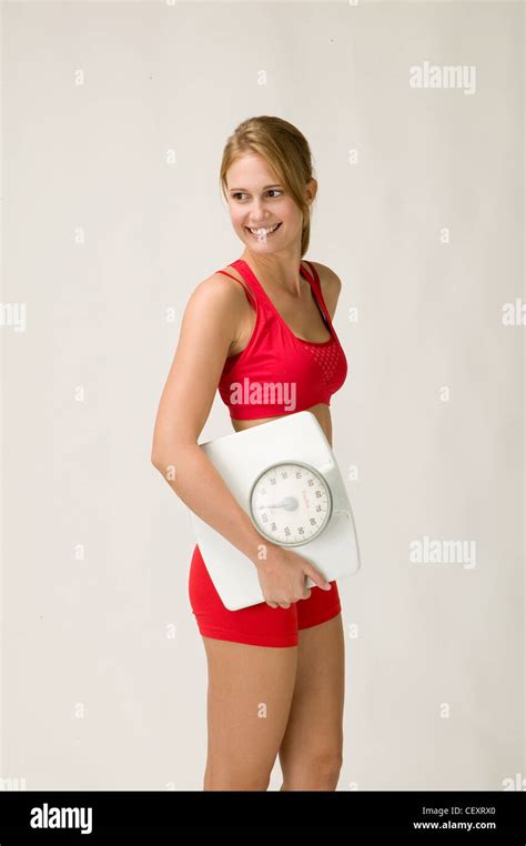 Female Blonde Hair Off Her Face Wearing A Red Cropped Bra Top And