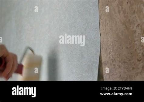 Close Up Sheet Of Blue Papper Wallpaper Is Glued To The Wall With A