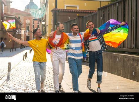 Couples Of Men Having Fun At The Demonstration With The Rainbow Flags