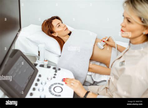 Female Doctor Performs Ultrasound Examination Of A Womens Pelvic