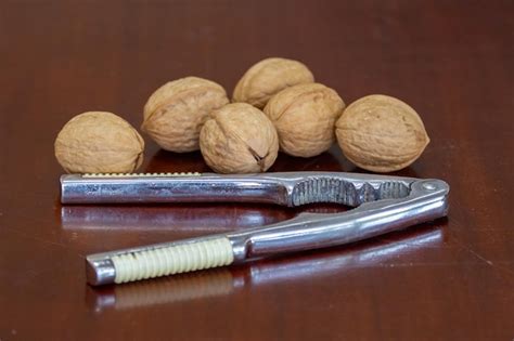 Premium Photo Cracking Christmas Nuts Using A Traditional Metal