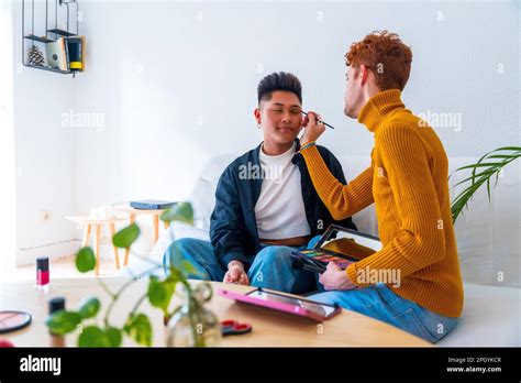 Beautiful Gay Couple Doing Makeup And Having Fun Being Romantic Indoors