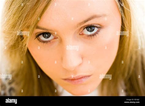 Blonde Teenage Girl Close Up Of Face Bent Slightly Forward But Blue