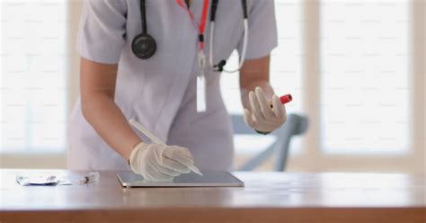 검사실에 서 있는 동안 디지털 태블릿에 혈액 검사를 작성하는 여성 의사의 클로즈업 보기 사진 Unsplash의 태국 이미지