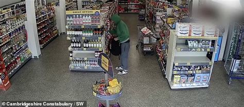 Moment Clumsy Shoplifter Is Caught On CCTV Stealing Wine And Sweets From A Corner Shop After His