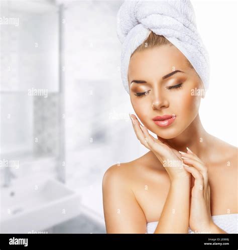 Beautiful Young Womans Face With A Towel On Her Head In Bathroom Stock