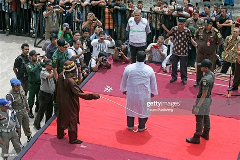 Indonesian Sharia Police Whips A Man During A Public Caning Ceremony