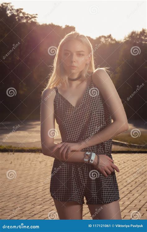 Tanned Blonde Model With Long Hair Wearing Black Romper Po Stock Image