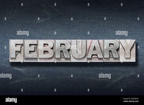 February Word Made From Metallic Letterpress On Dark Jeans Background