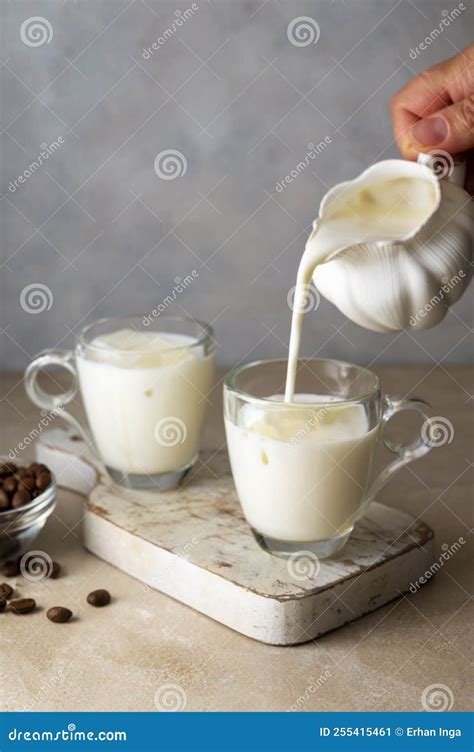 Pouring Milk In Glass Cups With Ice To Prepare Dalgona Coffee Step By