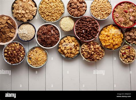 Assortment Of Different Kinds Cereals Placed In Ceramic Bowls On Table
