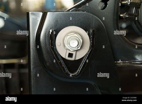A Detailed View Of A Metallic Fastener Mounted On A Machine Component