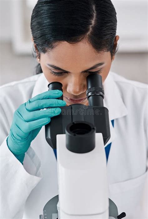 Theres Truth Under The Lens An Attractive Young Female Scientist Looking Through A Microscope