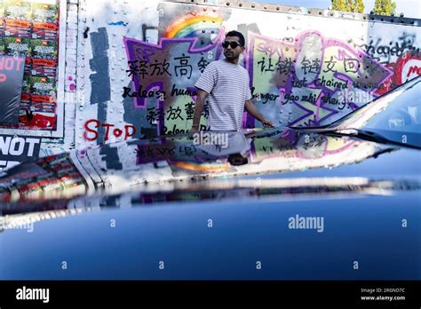 A Man Walks Past Anti Beijing Counter Slogans In Brick Lane Brick