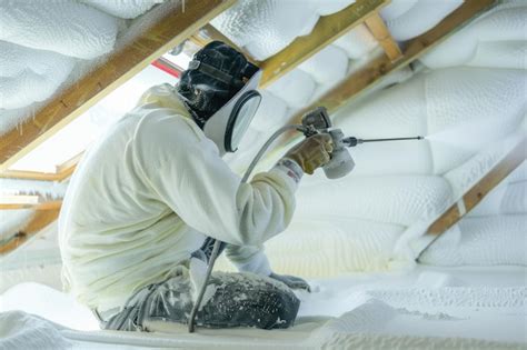 Technician Using Plural Component Gun To Spray Polyurethane Foam