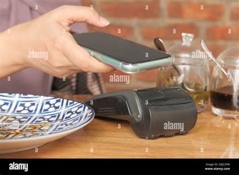 Payment Terminal Charging From A Smart Phone Contactless Payment Stock Photo Alamy