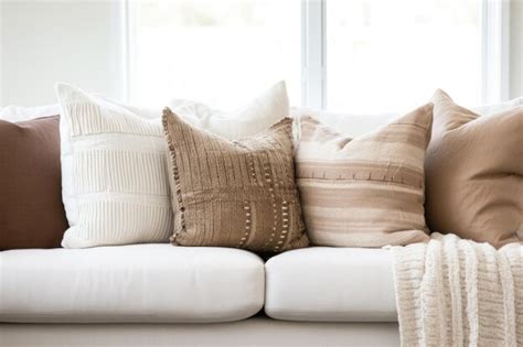 Premium Ai Image A Couch With Several Throw Pillows In Neutral Tones