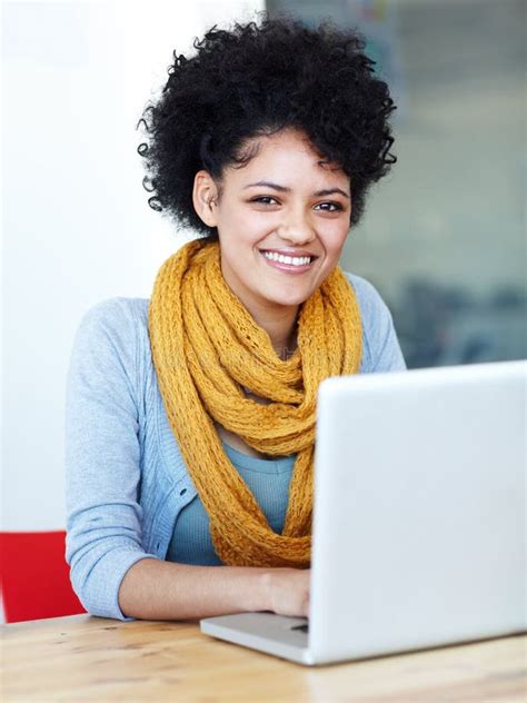 Happy With Her New Laptop An Attractive Young Woman Sitting At Her